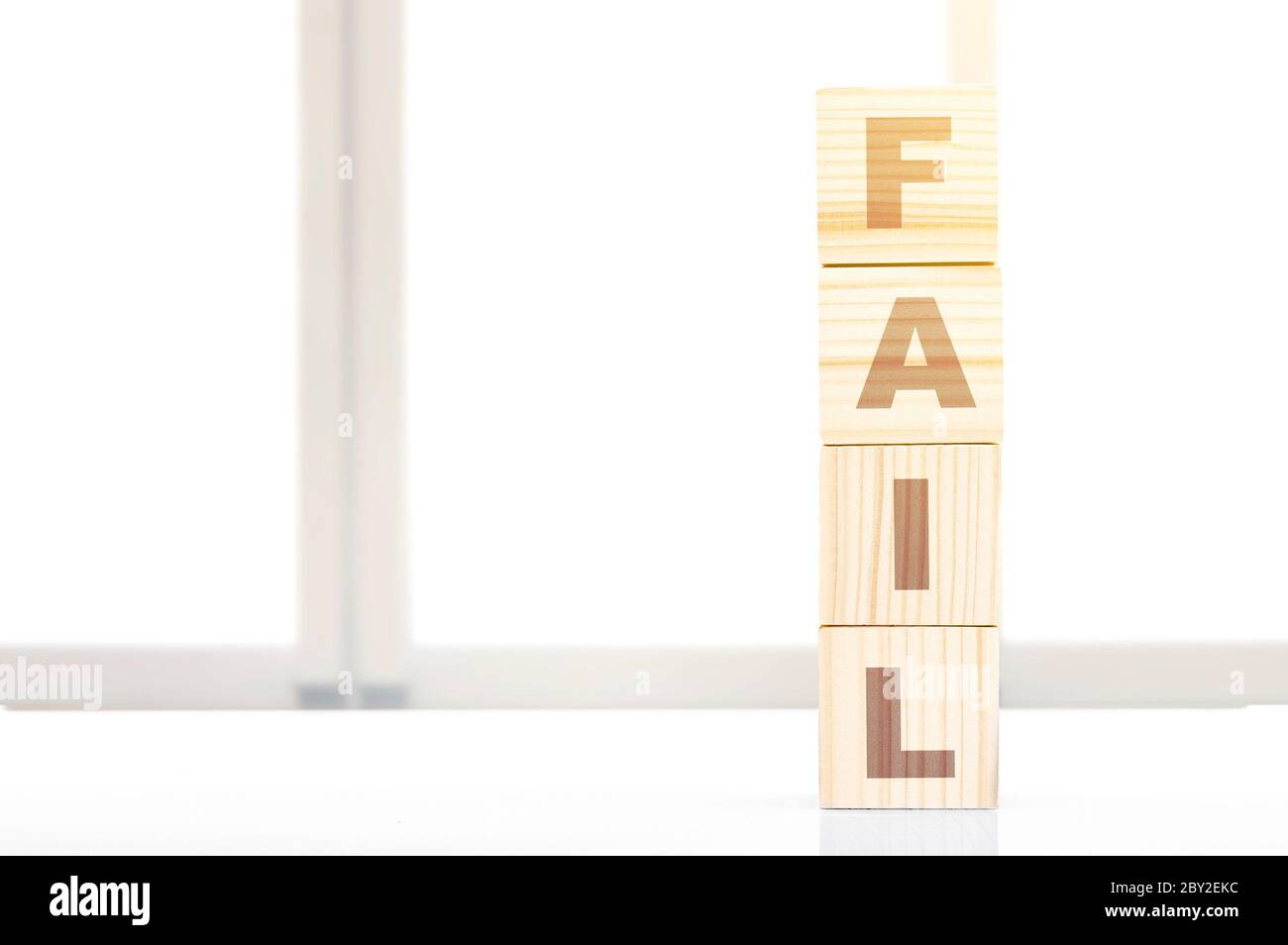Stacked wooden cube with the fail letter on the table Stock Photo - Alamy