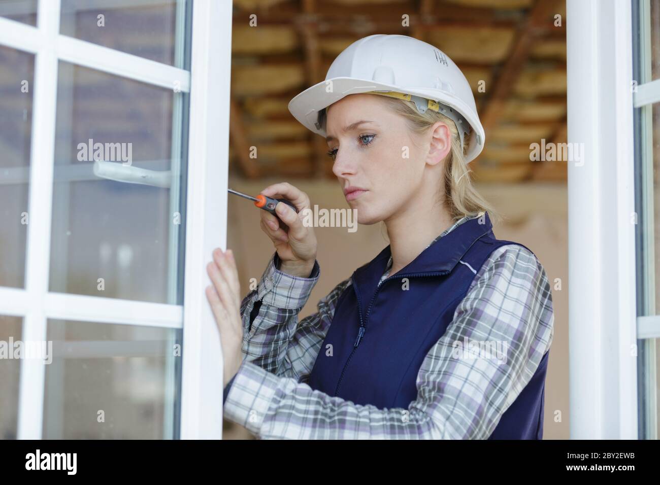 female worker installing a window Stock Photo - Alamy
