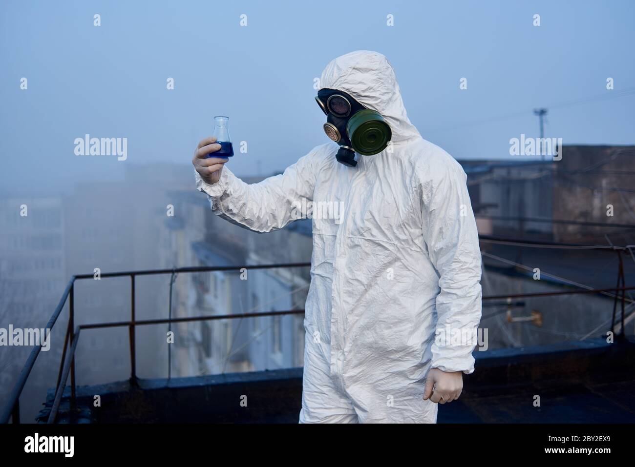 Scientist wearing protective suit and gas mask, conducting the study ...