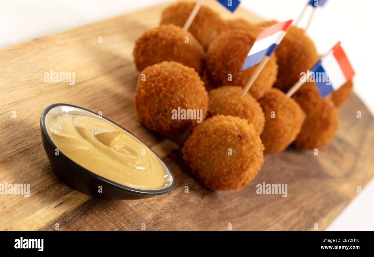 Dutch traditional snack bitterbal on a serving board, dutch flag ...