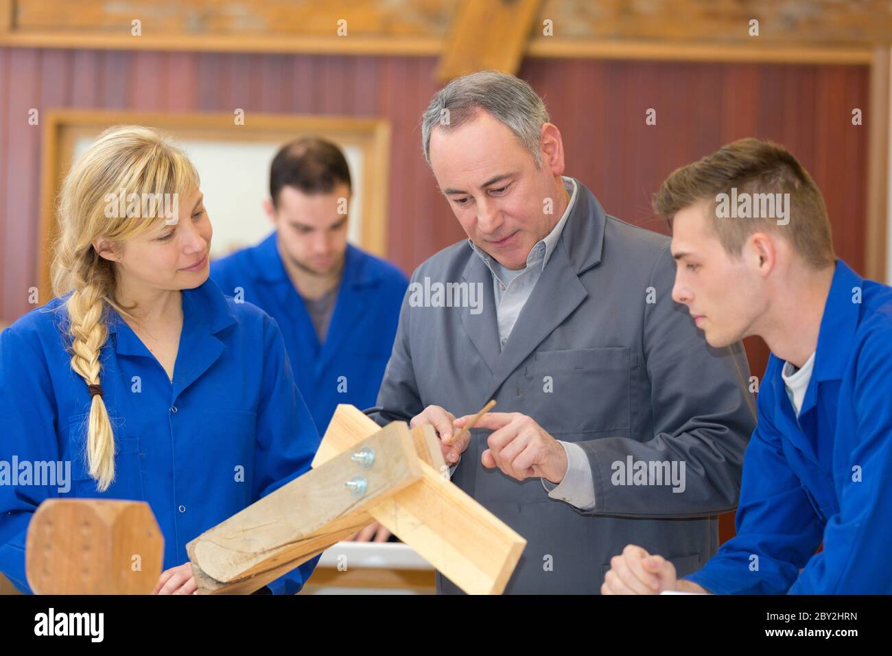 carpentry apprentice studying a technique Stock Photo - Alamy