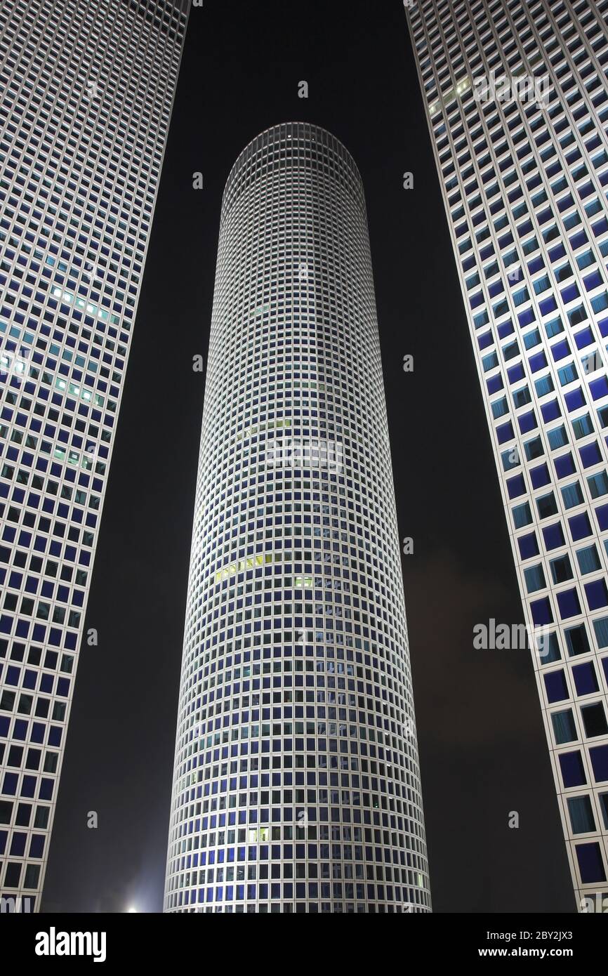Round, square and triangular skyscrapers at night Stock Photo - Alamy