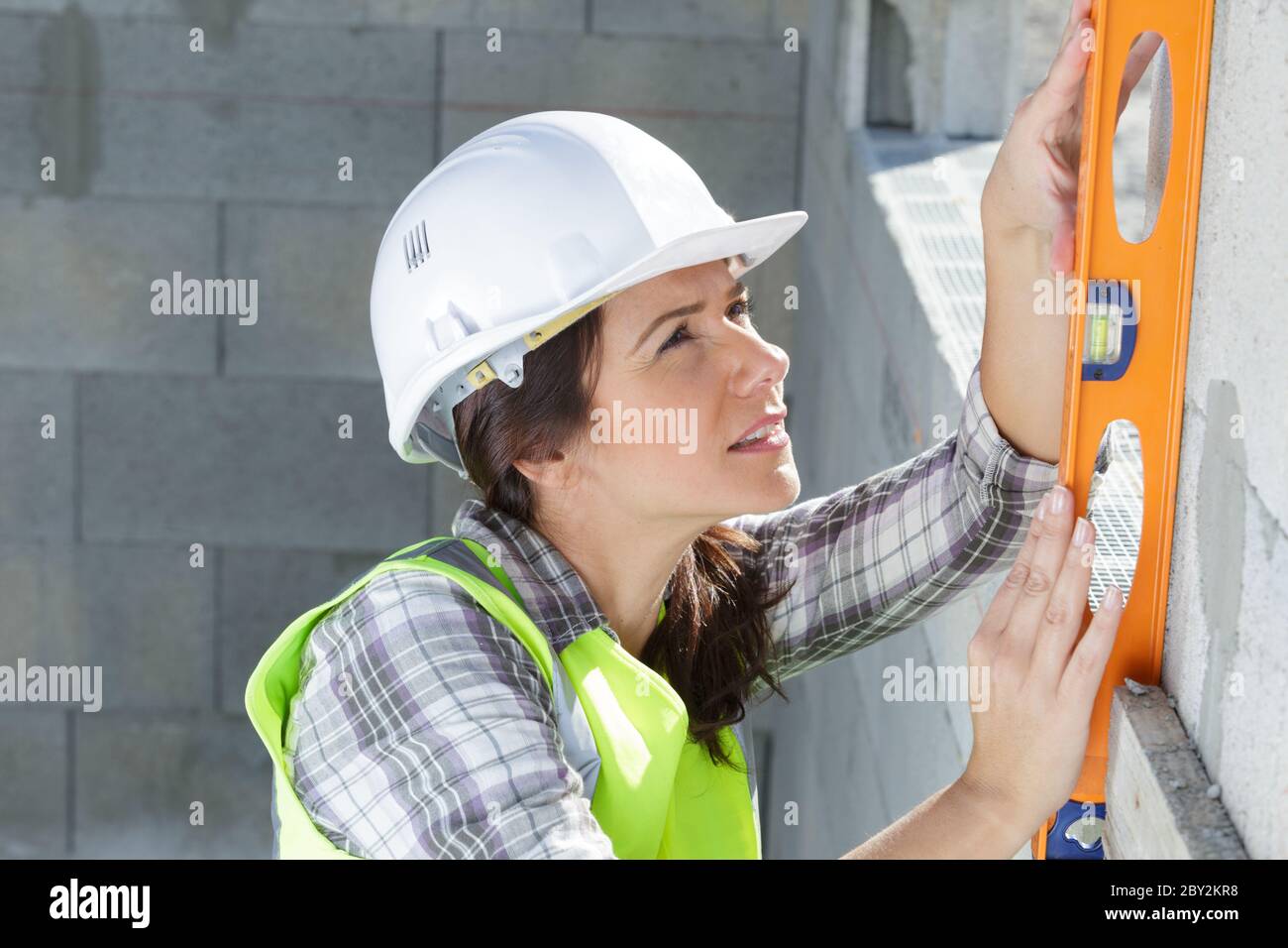 woman holding builders level Stock Photo - Alamy