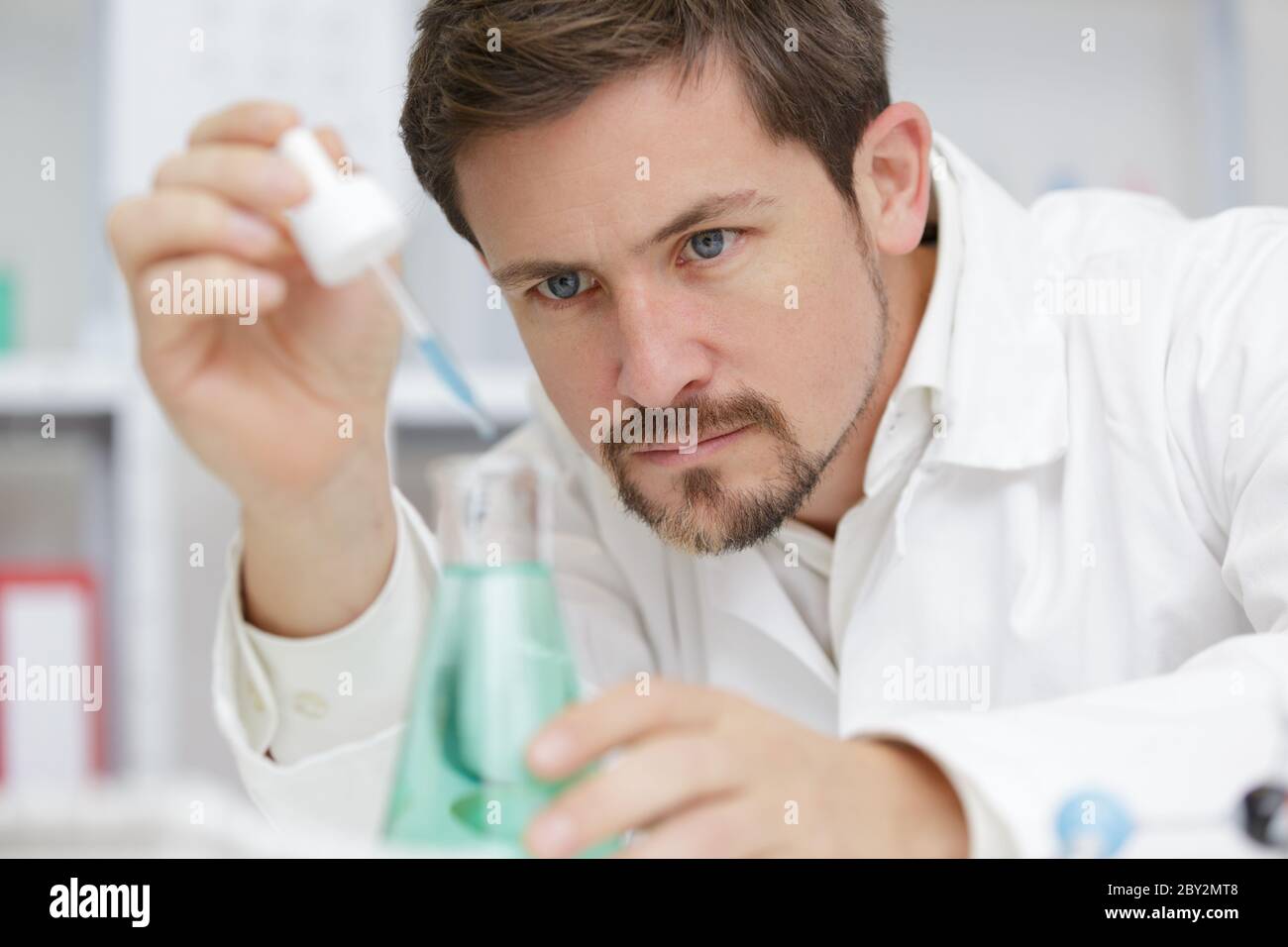 young male scientist doing experiments in laboratory Stock Photo - Alamy