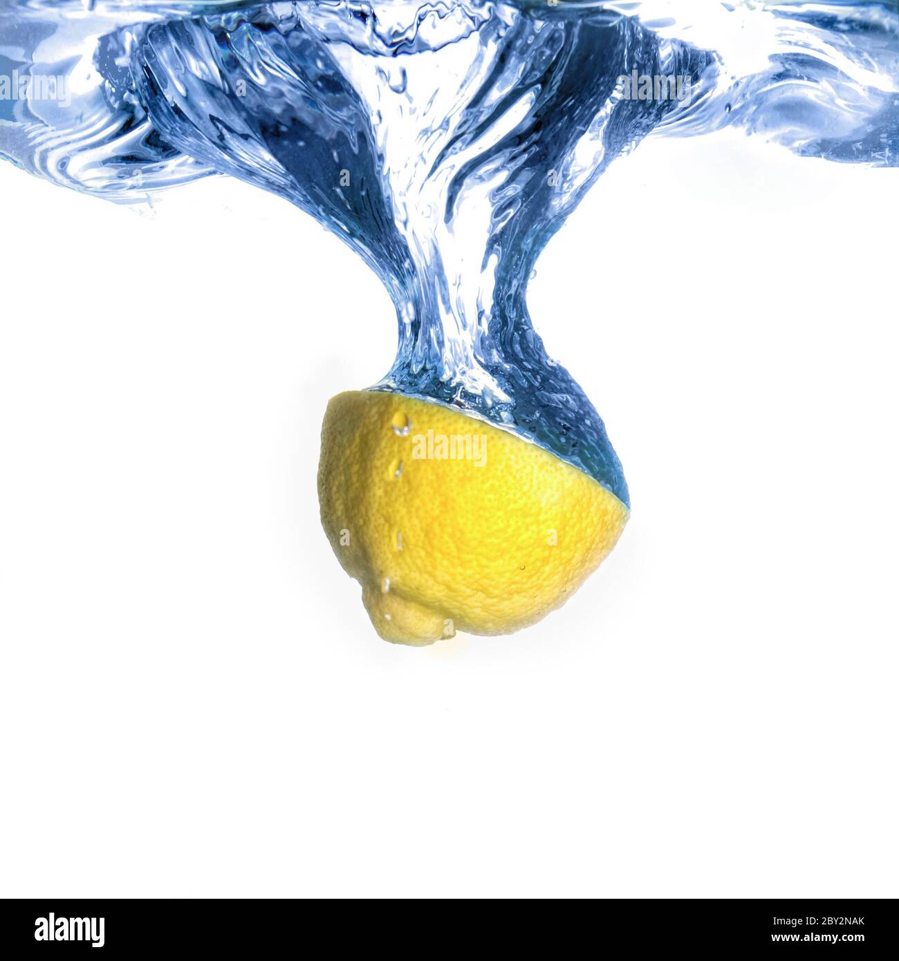Fresh lemon dropped into water with bubbles isolated on white Stock ...