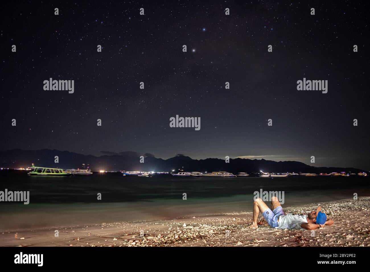PANORAMIC NIGHT SCENE PERSON ON SAND FROM A BEACH Stock Photo - Alamy