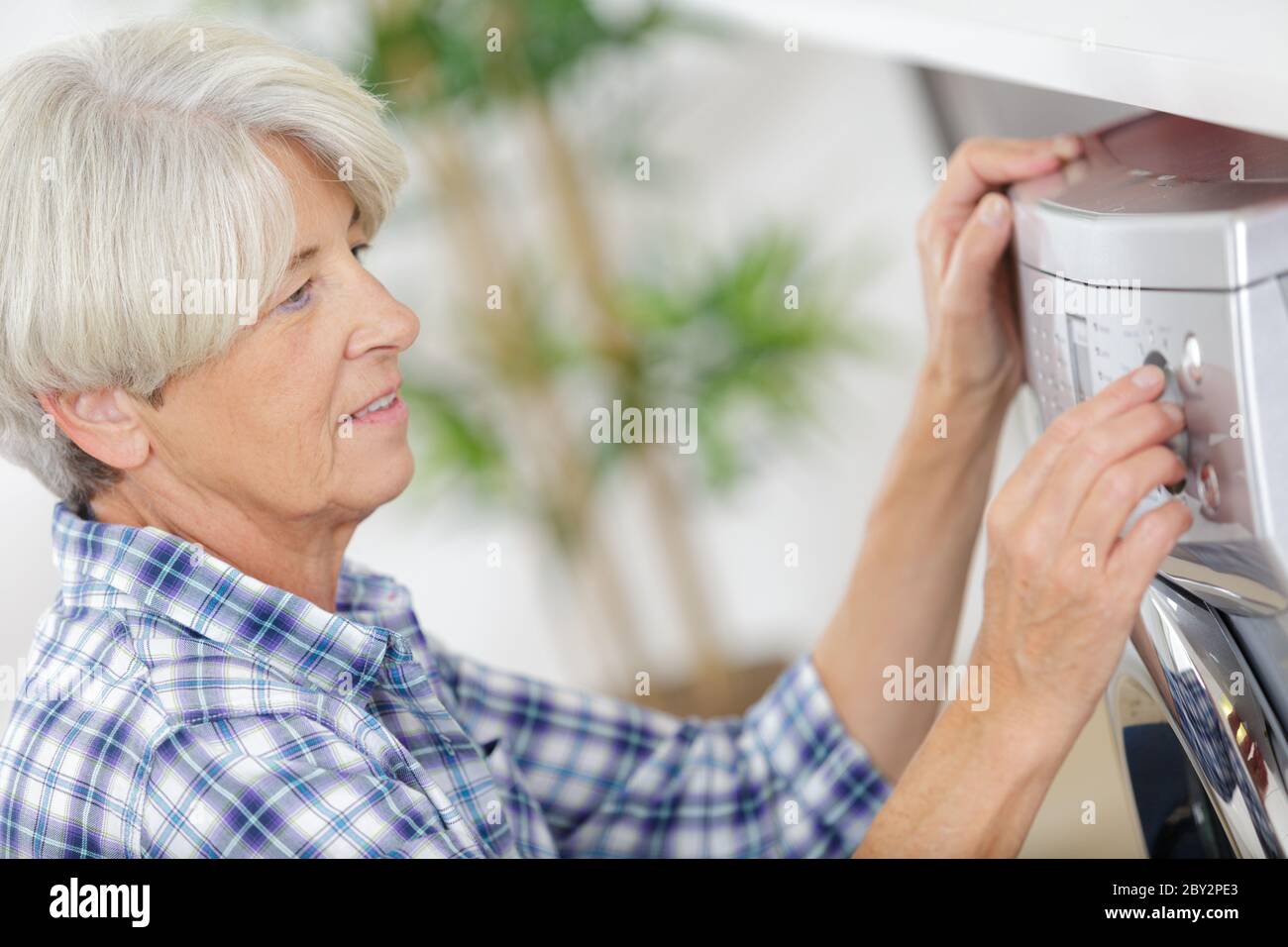 happy housewife using washing machine at home Stock Photo - Alamy