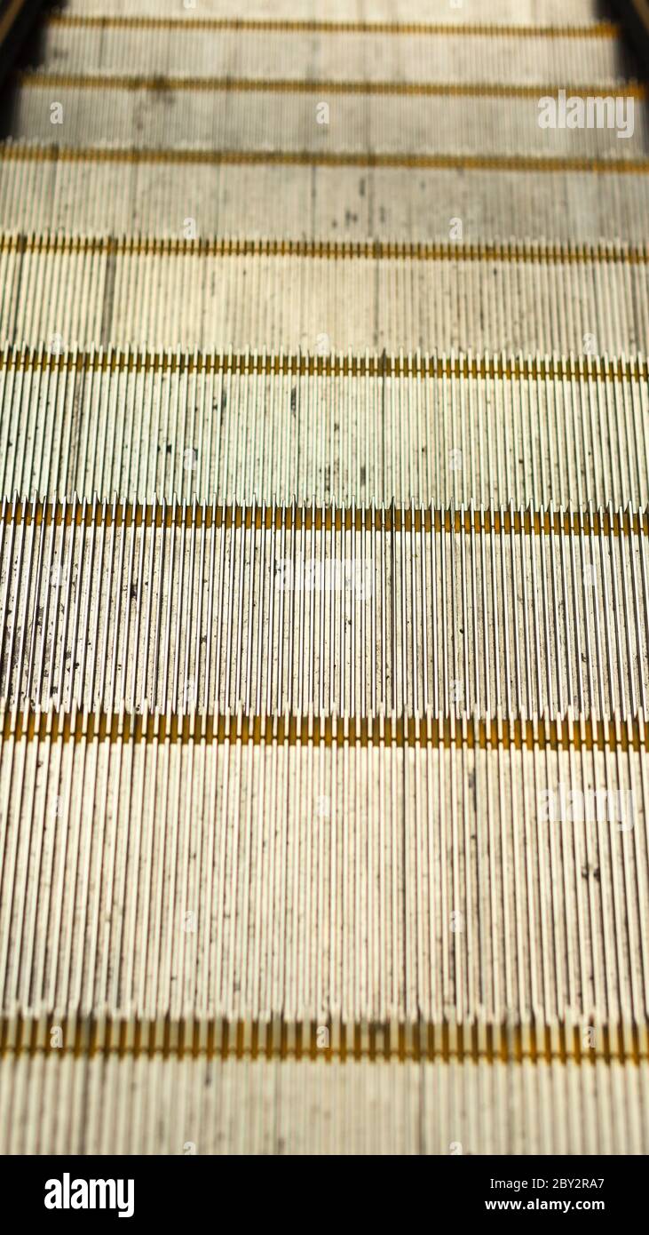Closeup steel escalator steps in an office building or mall indoor ...