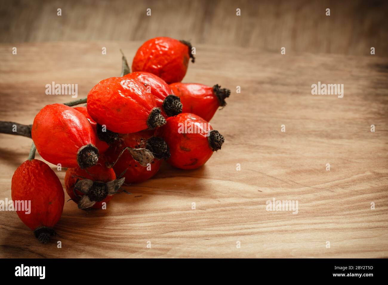 Hawthorn on wooden rustic table background. Rose hips haw fruit of the ...