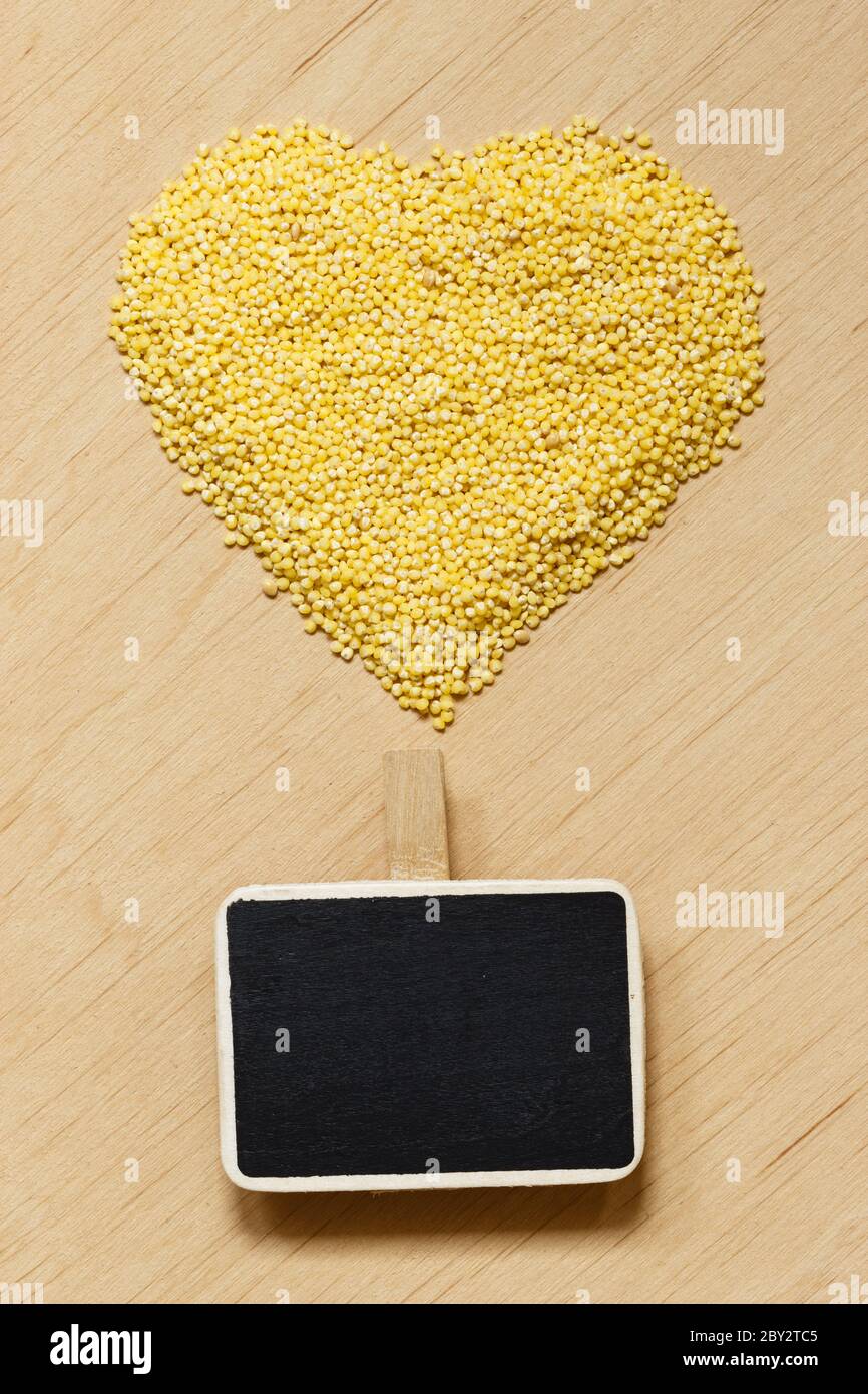 Dieting healthy food. Millet groats heart shaped and small blackboard ...