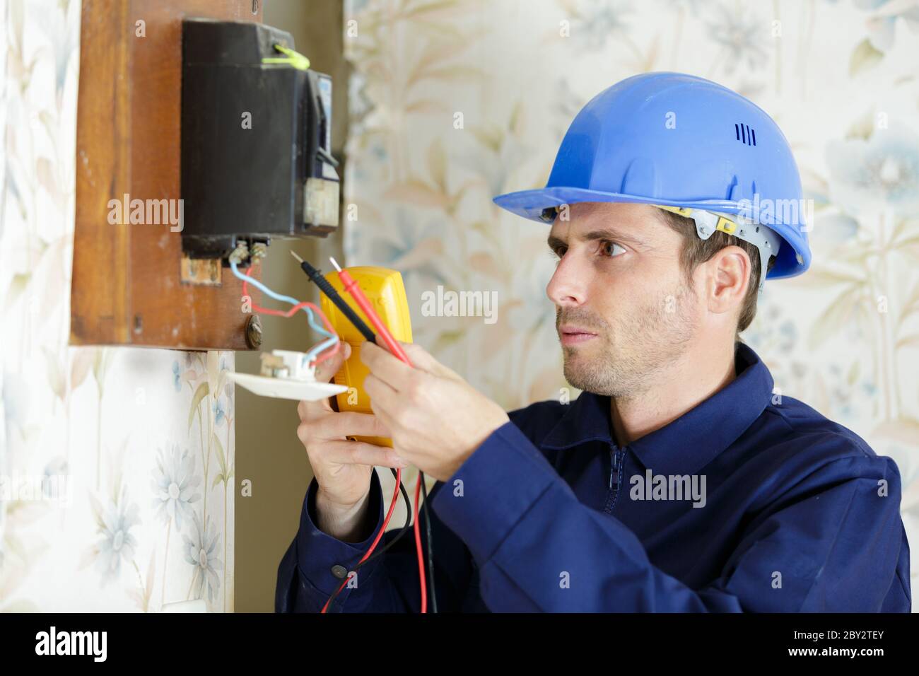 an engineer measuring with a multimeter Stock Photo - Alamy