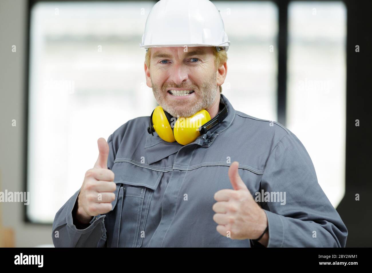 happy laborer showing okay sign Stock Photo - Alamy