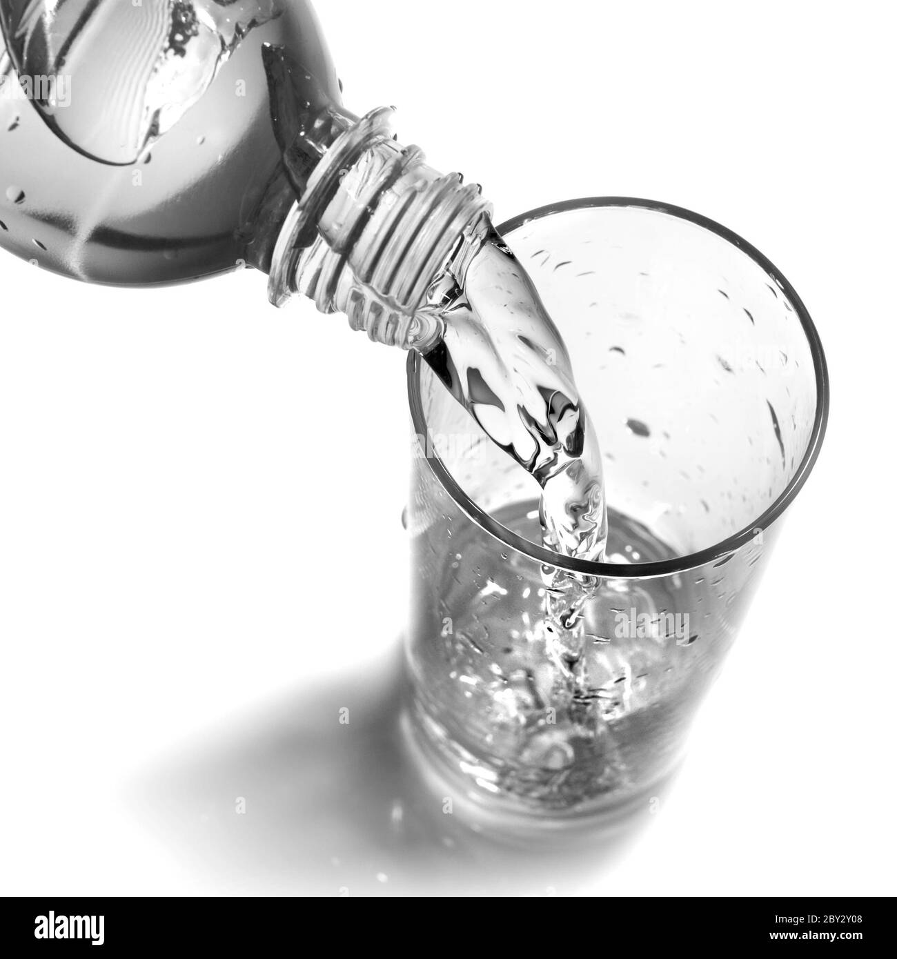 water pouring into glass from bottle isolated on white Stock Photo - Alamy
