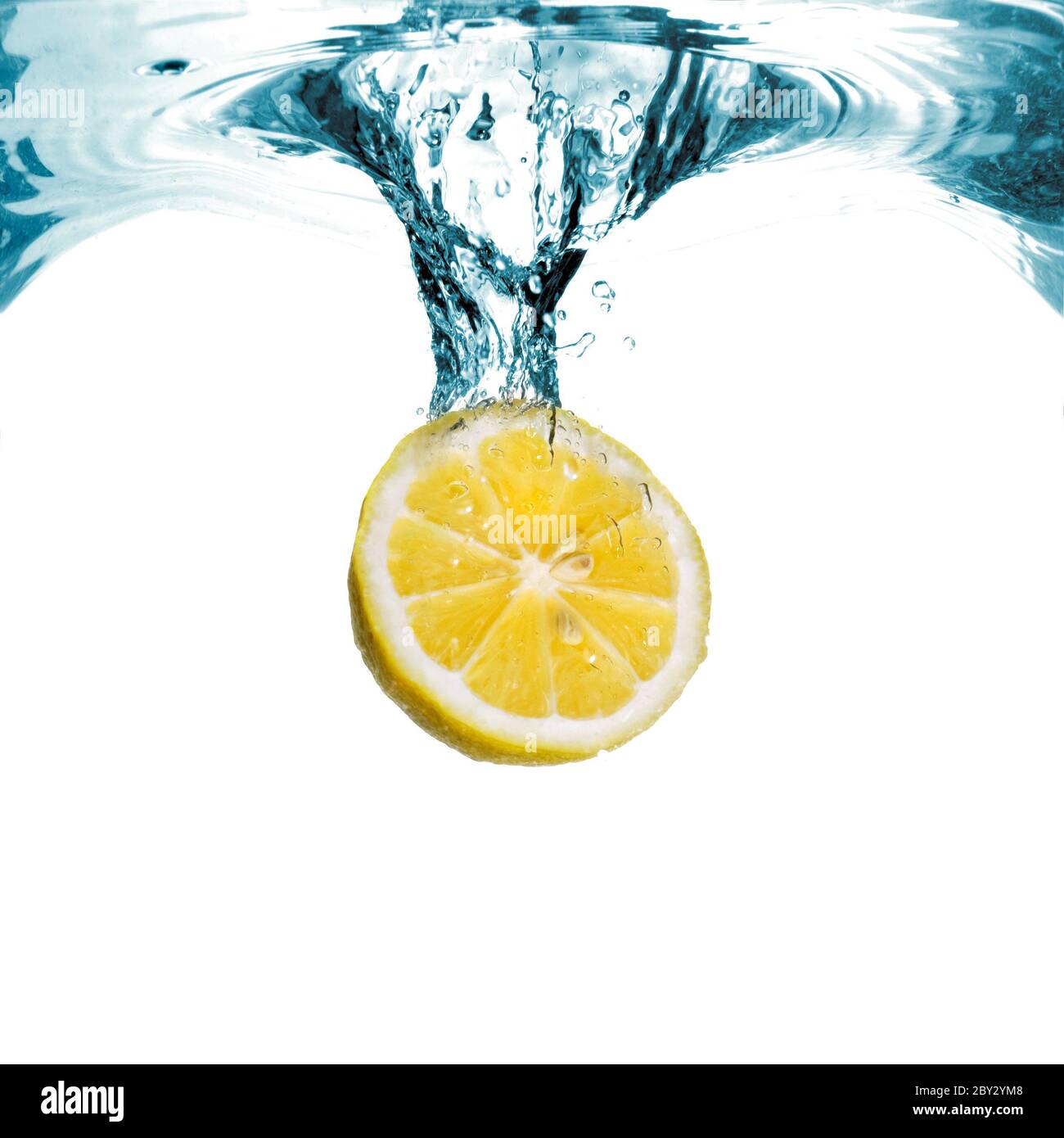 Fresh lemon dropped into water with bubbles isolated on white Stock ...