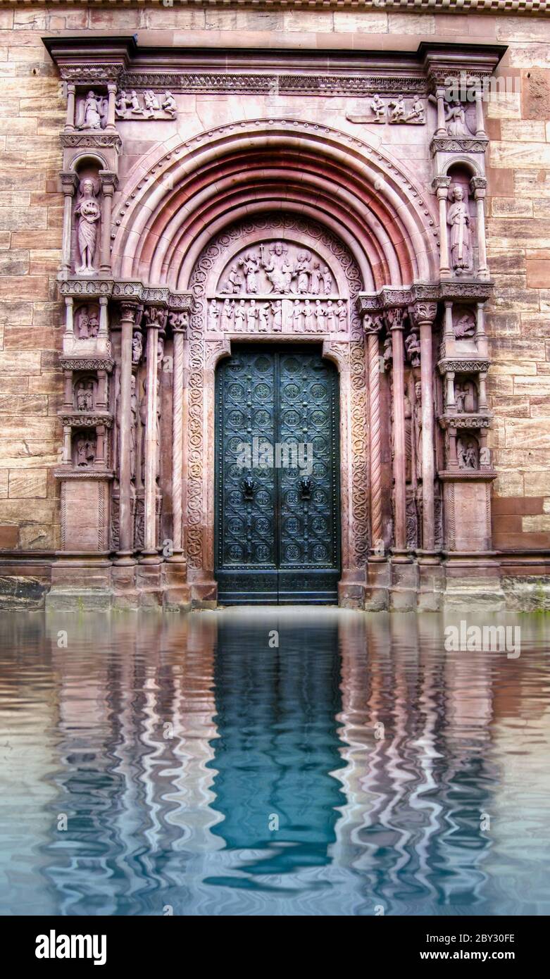 Antique cathedral gate in water reflection. Old urban architecture ...