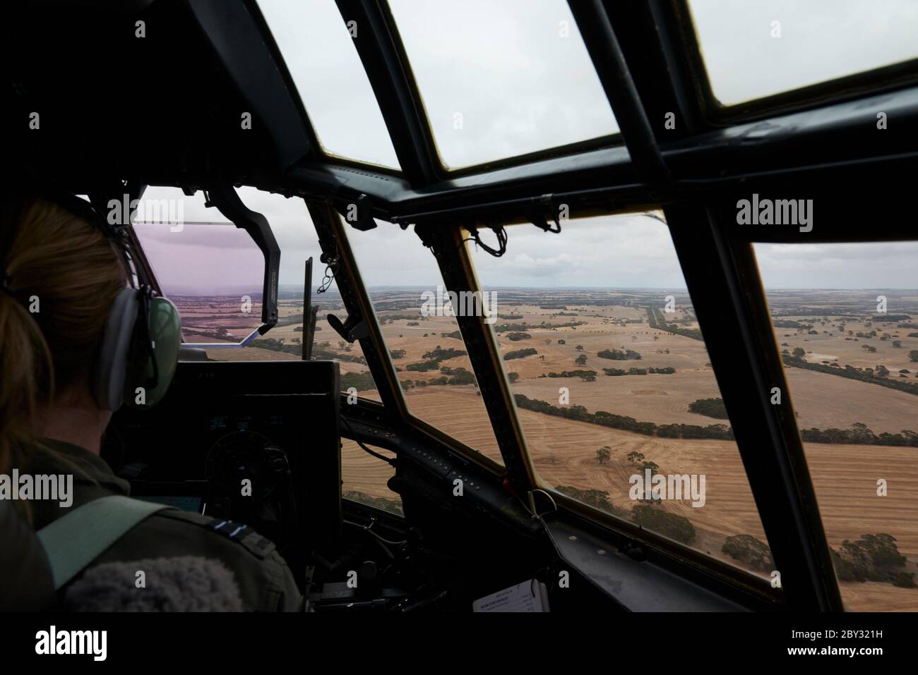 The pilot at the nose flying a Royal Australian Air Force Lockheed C ...