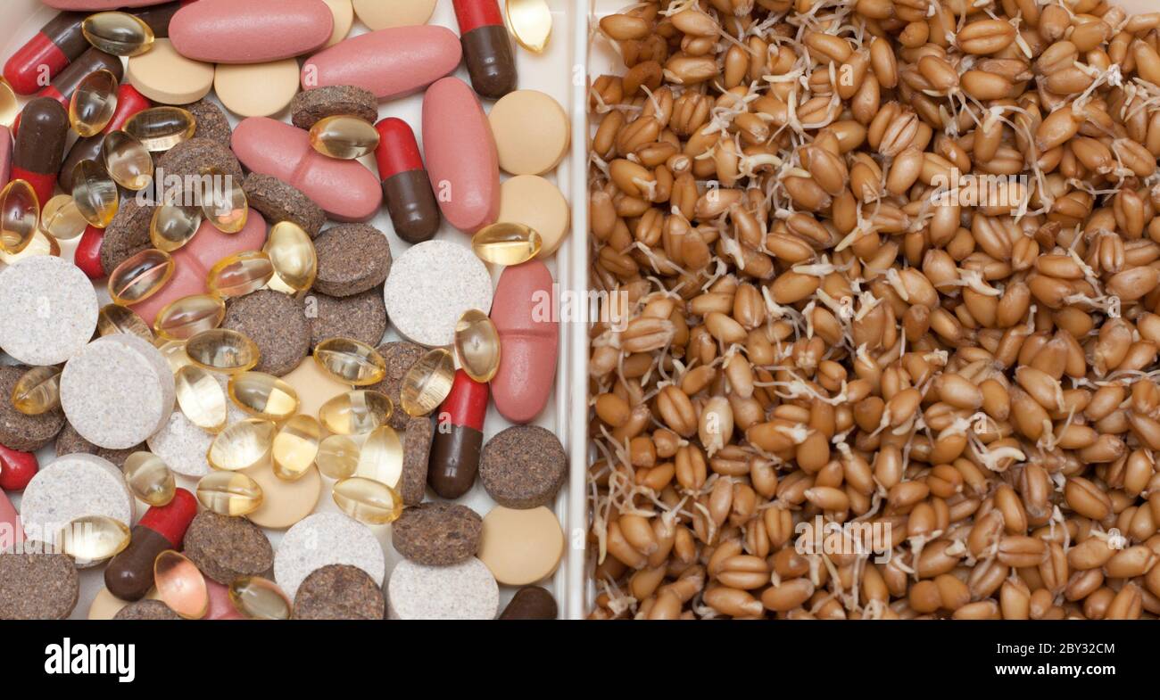 Pill and tablet vs wheat Stock Photo - Alamy