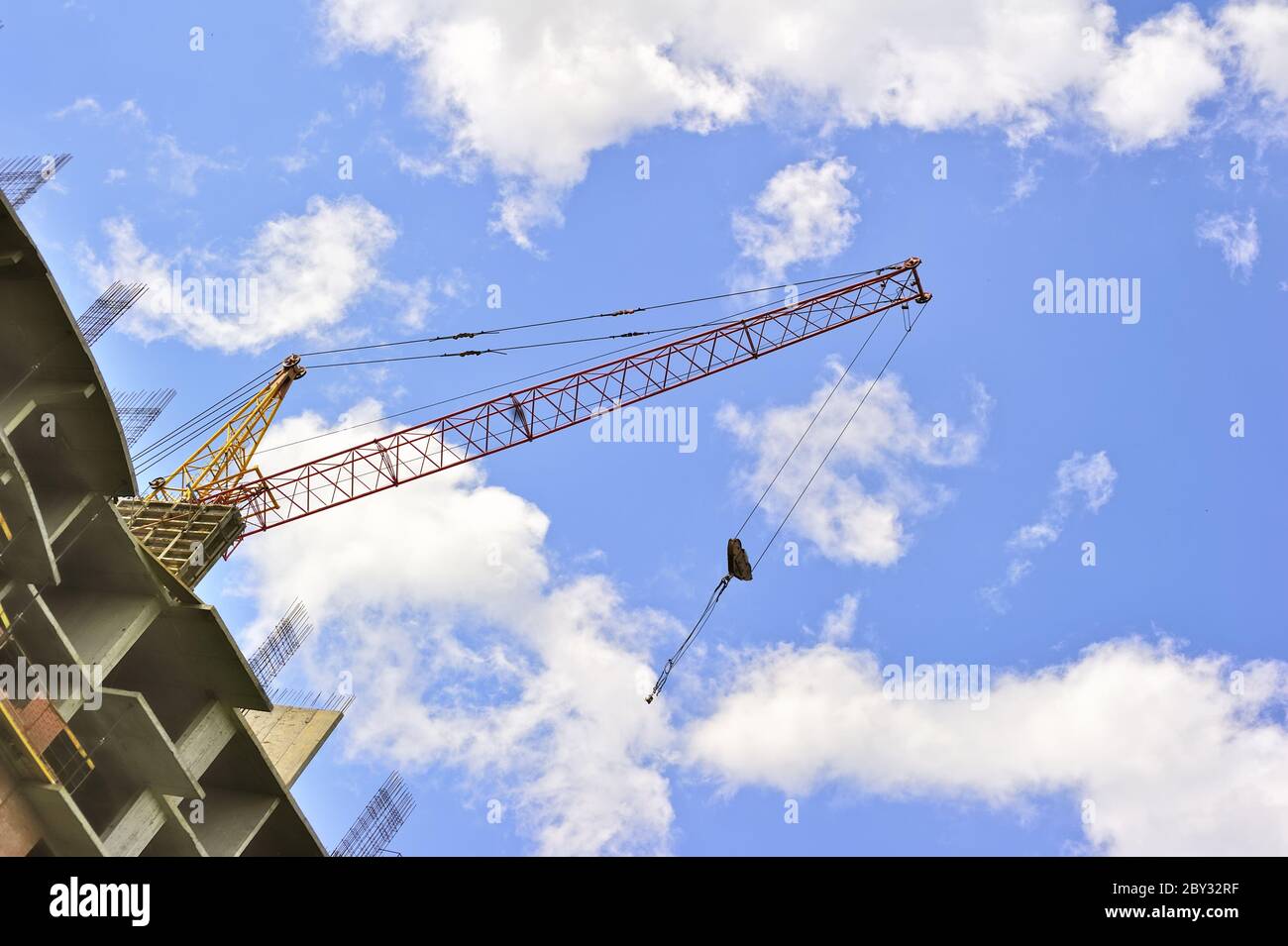 Building with elevating crane Stock Photo - Alamy