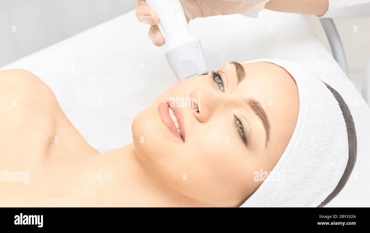 Vacuum face cosmetology equipment. Facial salon cleaning. Youn girl ...