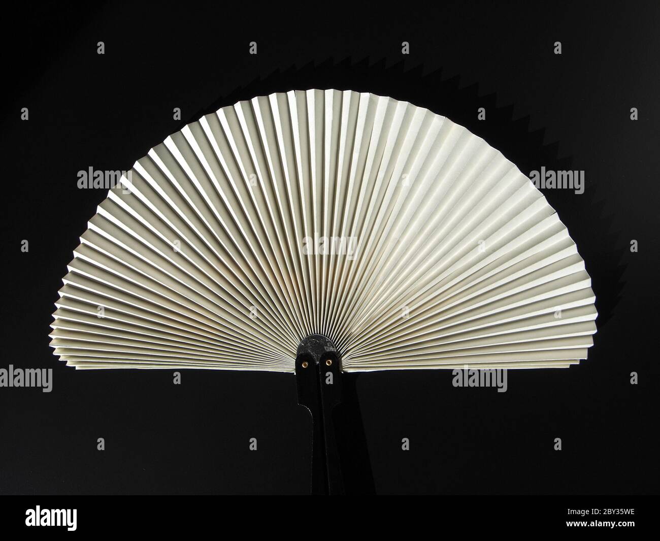 Hand held fan Stock Photo - Alamy
