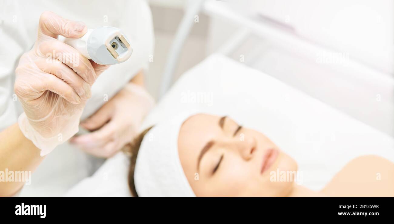 Vacuum face cosmetology equipment. Facial salon cleaning. Youn girl ...