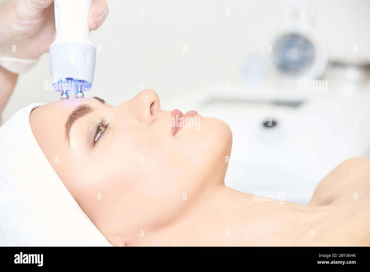 Microcurrent light esthetics procedure. Beauty girl face. Cosmetology ...