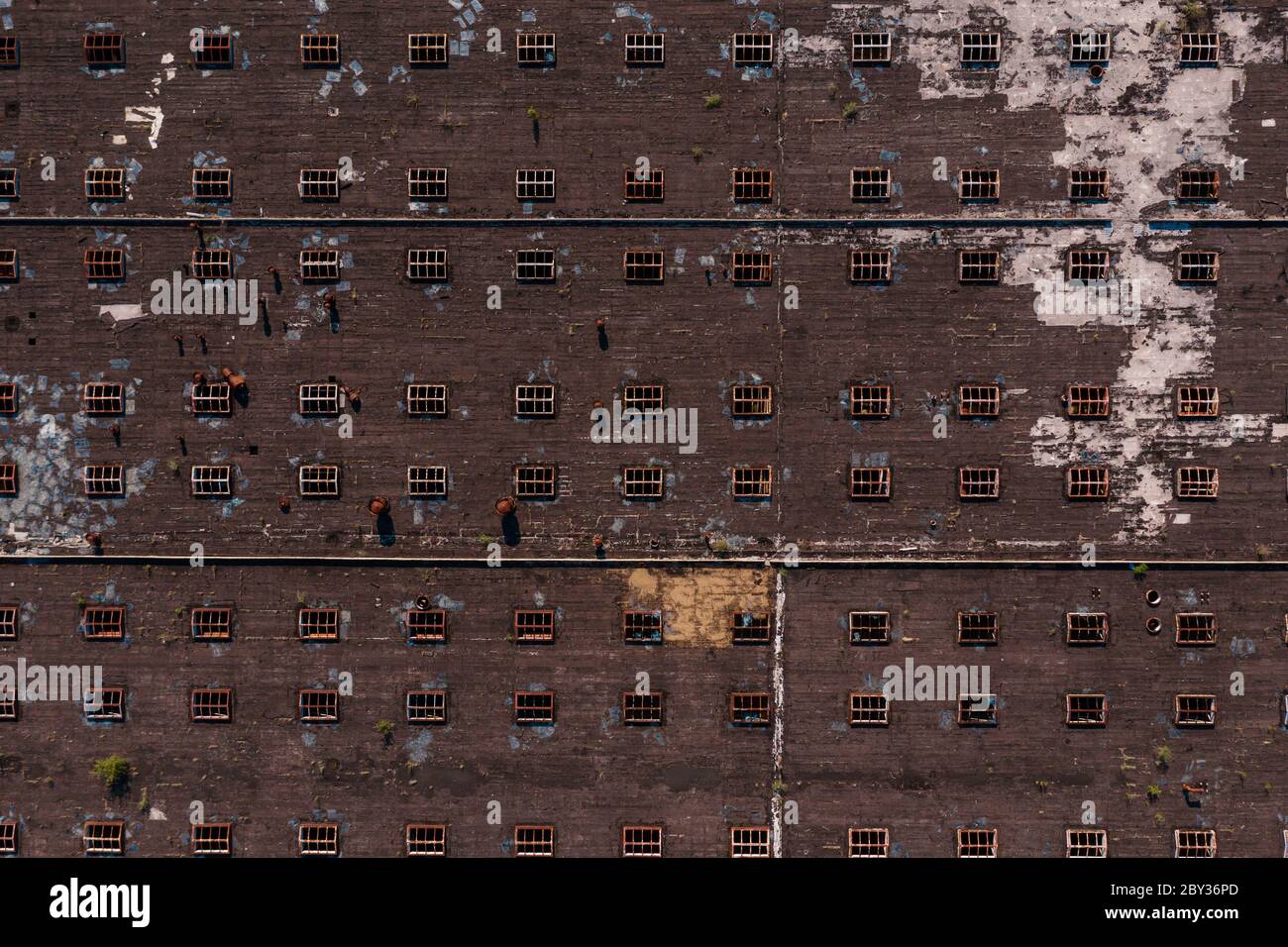 An aerial view of an large industrial factory roof taken with a drone ...