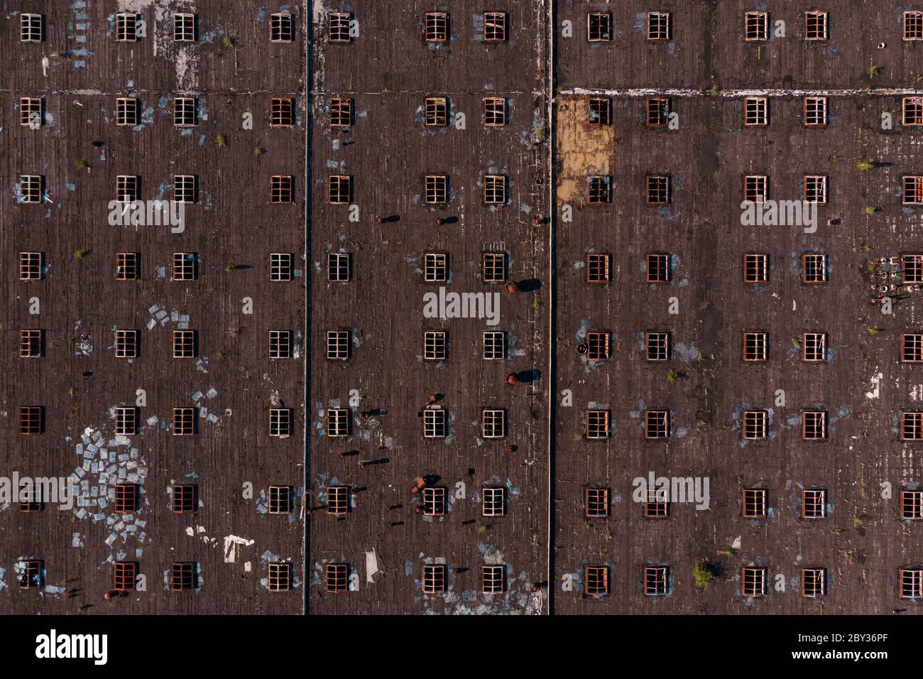 An aerial view of an large industrial factory roof taken with a drone ...