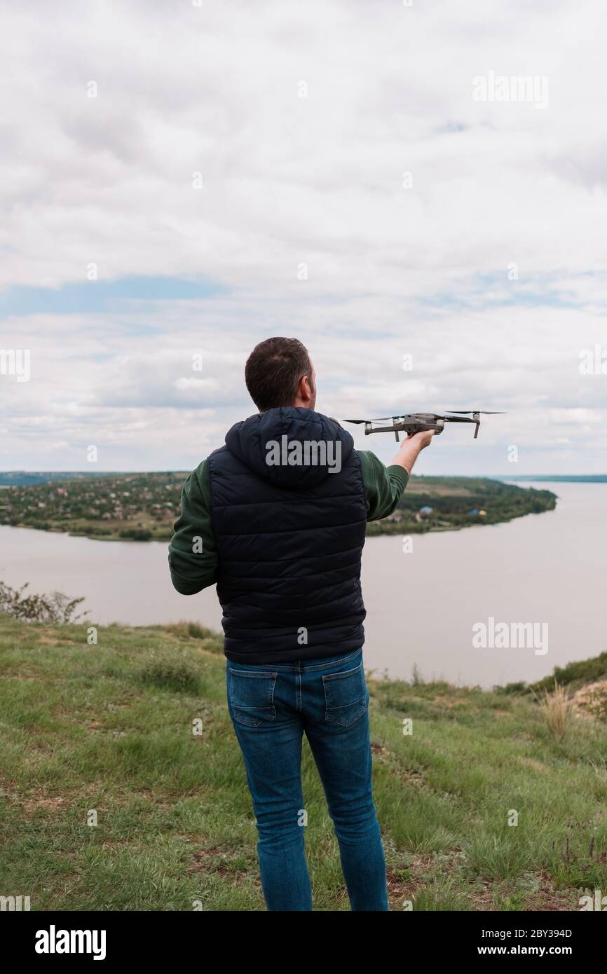 Young Man Piloting Drone Outdoor In Nature Guy Testing Aerial Unmanned Vehicle At Nature