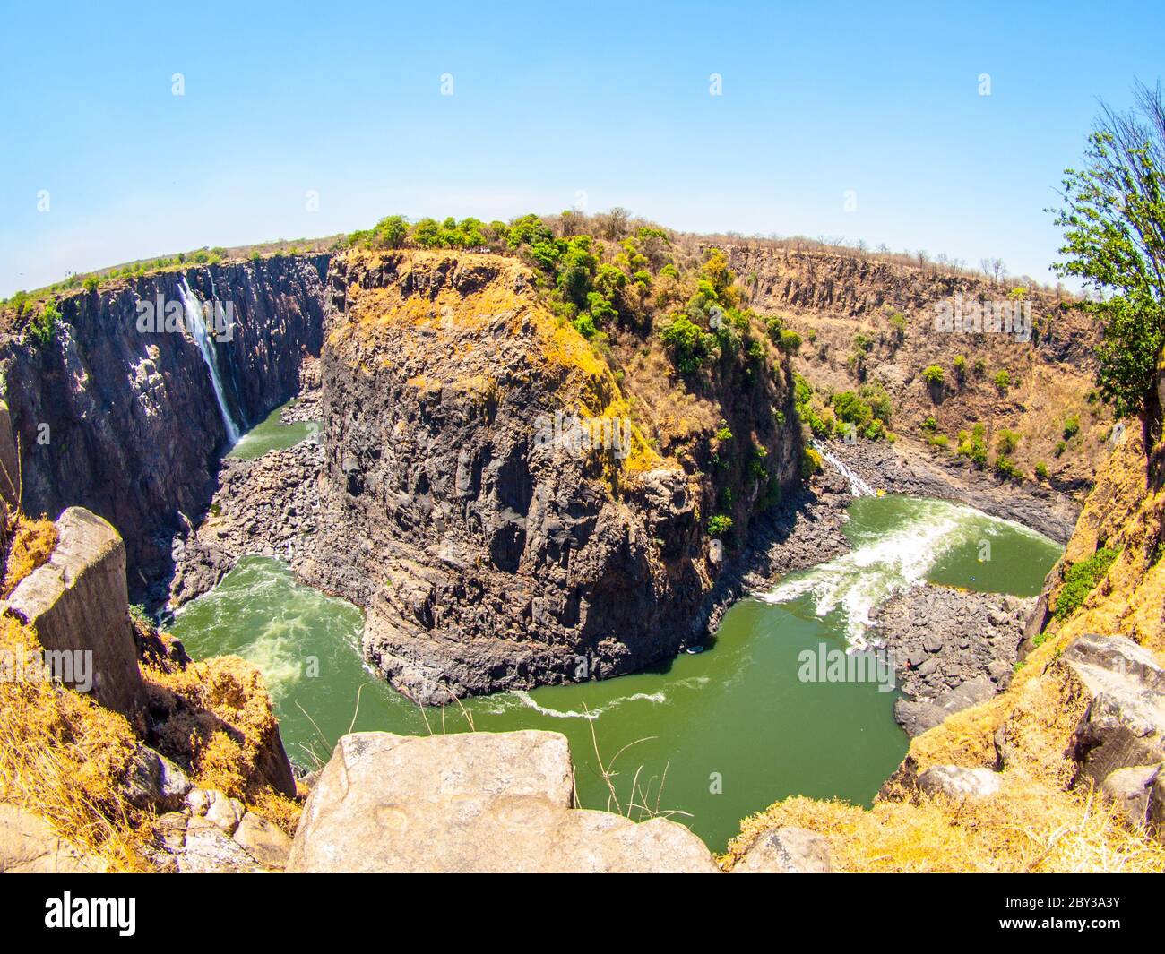 Victoria Falls on Zambezi River. Dry season. Border between Zimbabwe ...