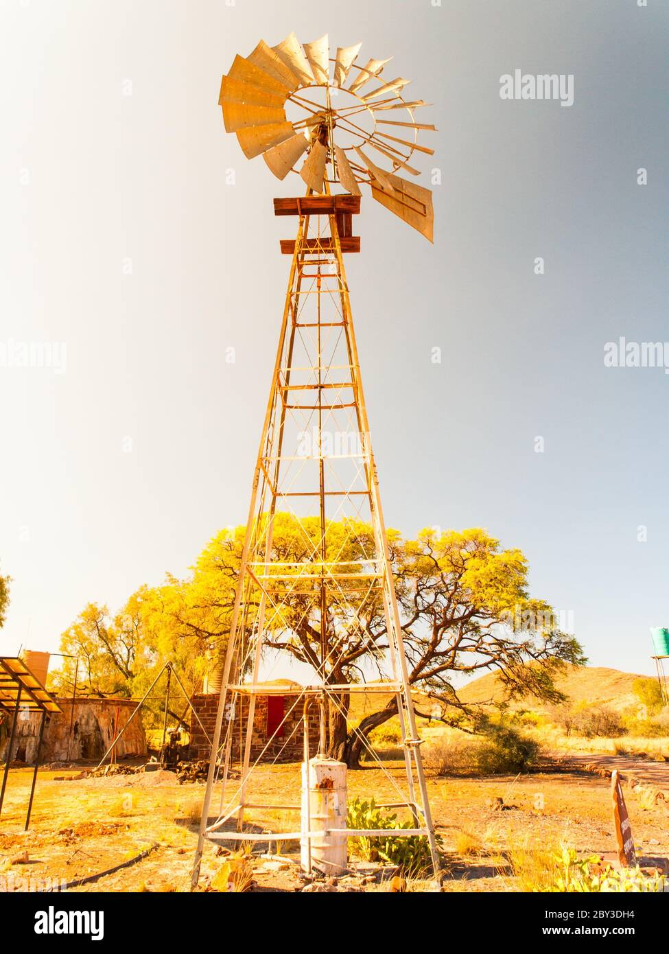 Old windmill water pump in dry landscape. Metallic tower construction ...