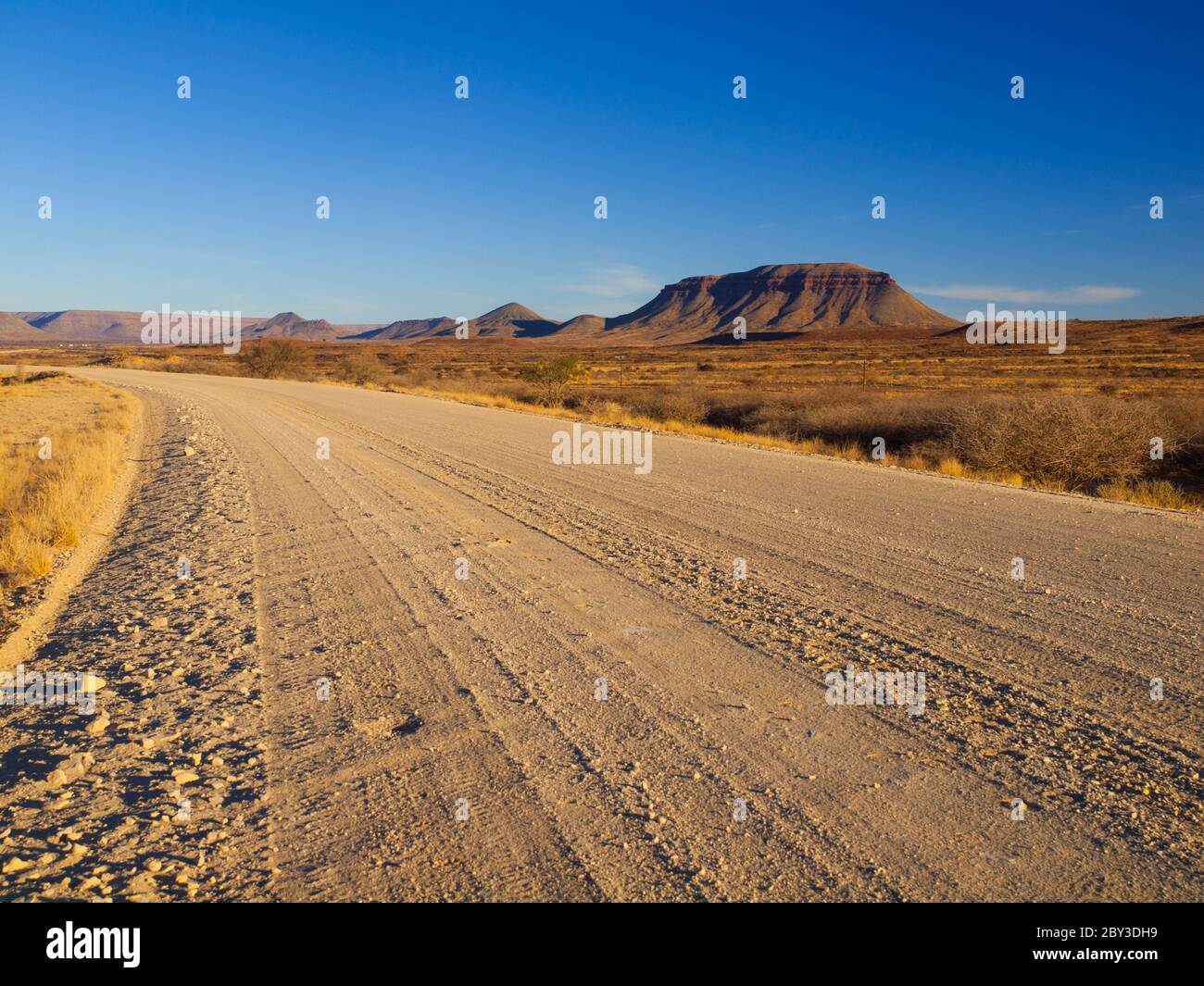 Gravel road and table mountain in southern Namibia Stock Photo - Alamy