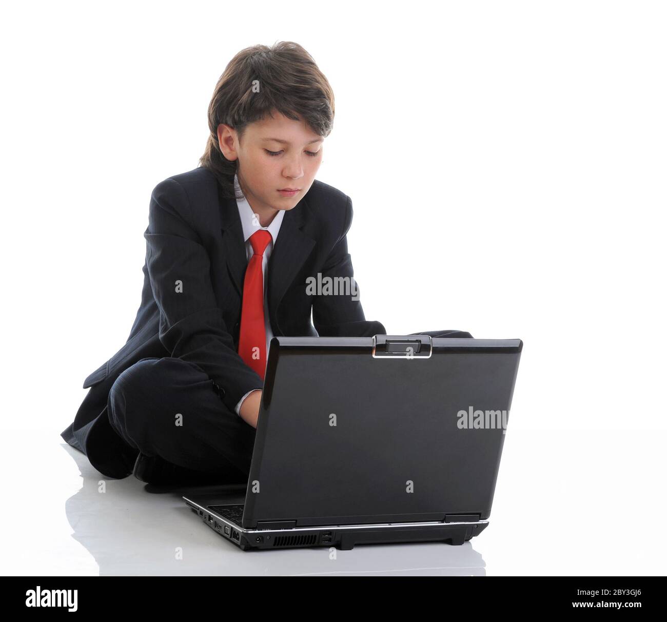 boy in business suit sitting in front of computer Stock Photo - Alamy