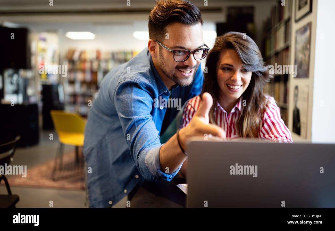 Students are studying together in library. Couple, study, technology ...