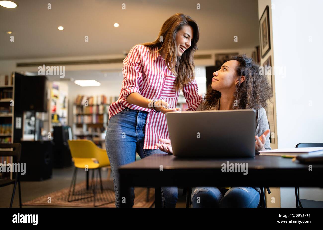 Group of college students studying in the school library Stock Photo ...