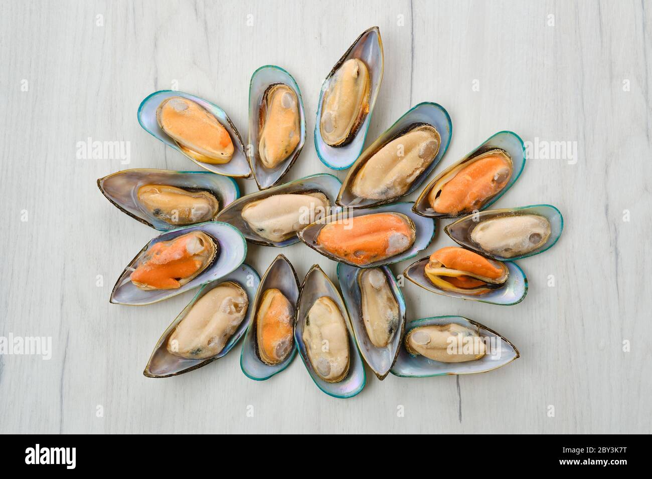 Raw large mussels in half shell on wooden background Stock Photo - Alamy