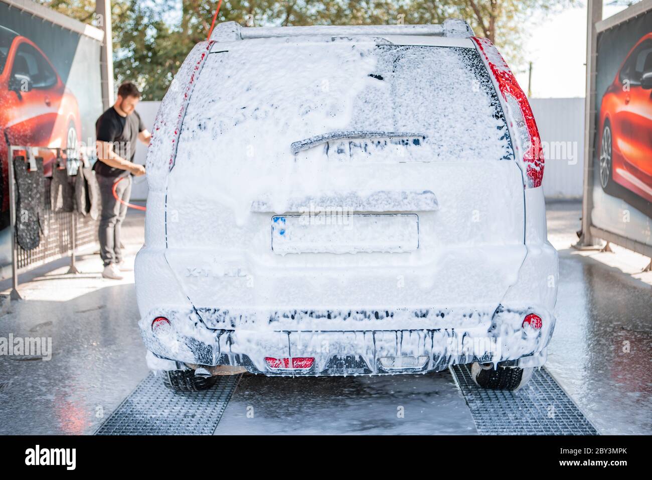 strong man washing car at self carwash outdoors Stock Photo - Alamy