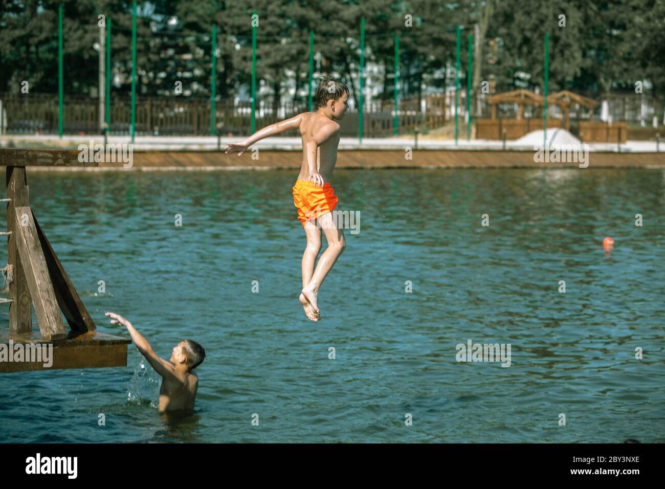 Kids jump into lake hi-res stock photography and images - Alamy
