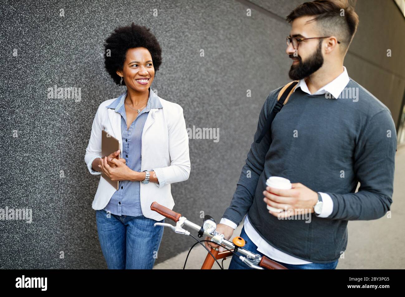 Business people talking outside with coffee, break relaxing time ...