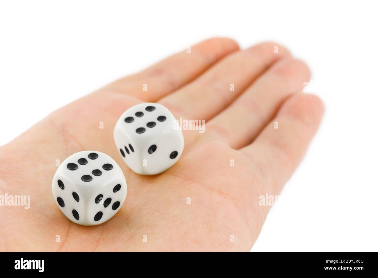 Two dices in hand Stock Photo - Alamy