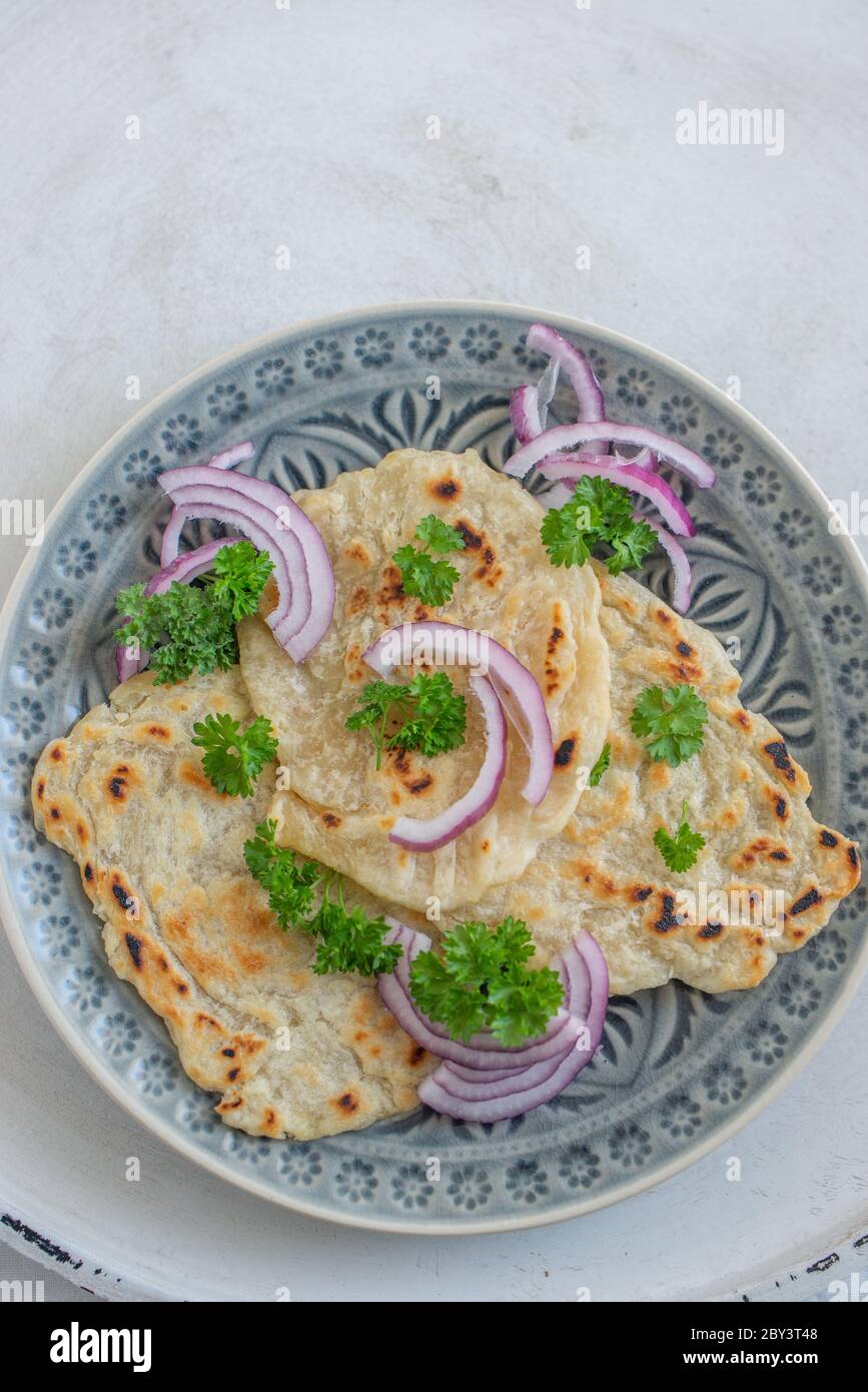 Onion naan - traditional indian bread. pita bread or scones with green ...