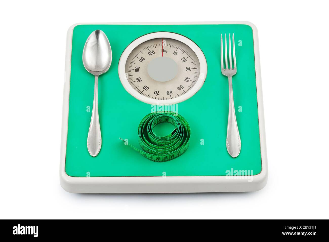 Fork and spoon on weight scale Stock Photo - Alamy