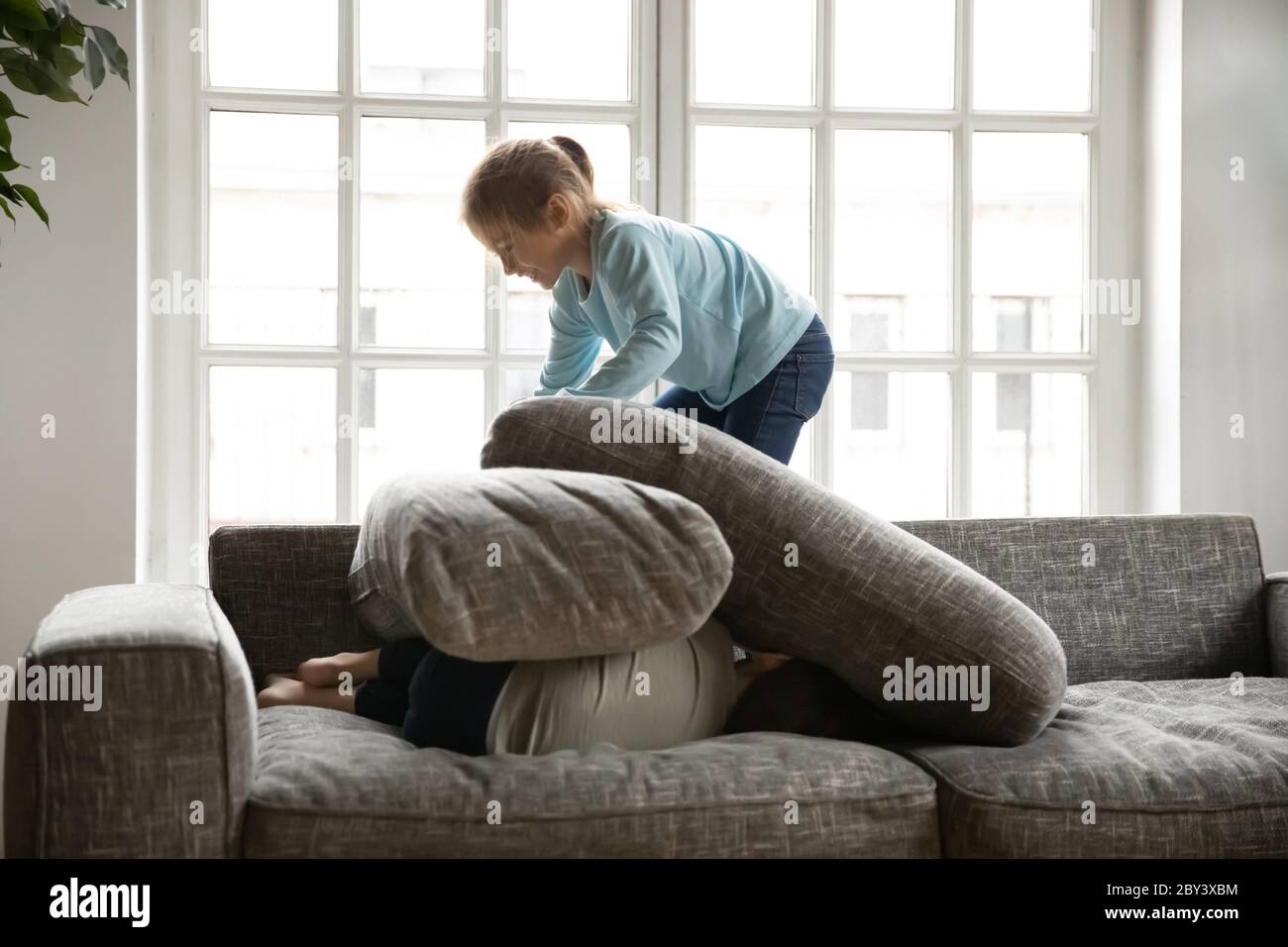 Little children have fun playing on couch Stock Photo - Alamy