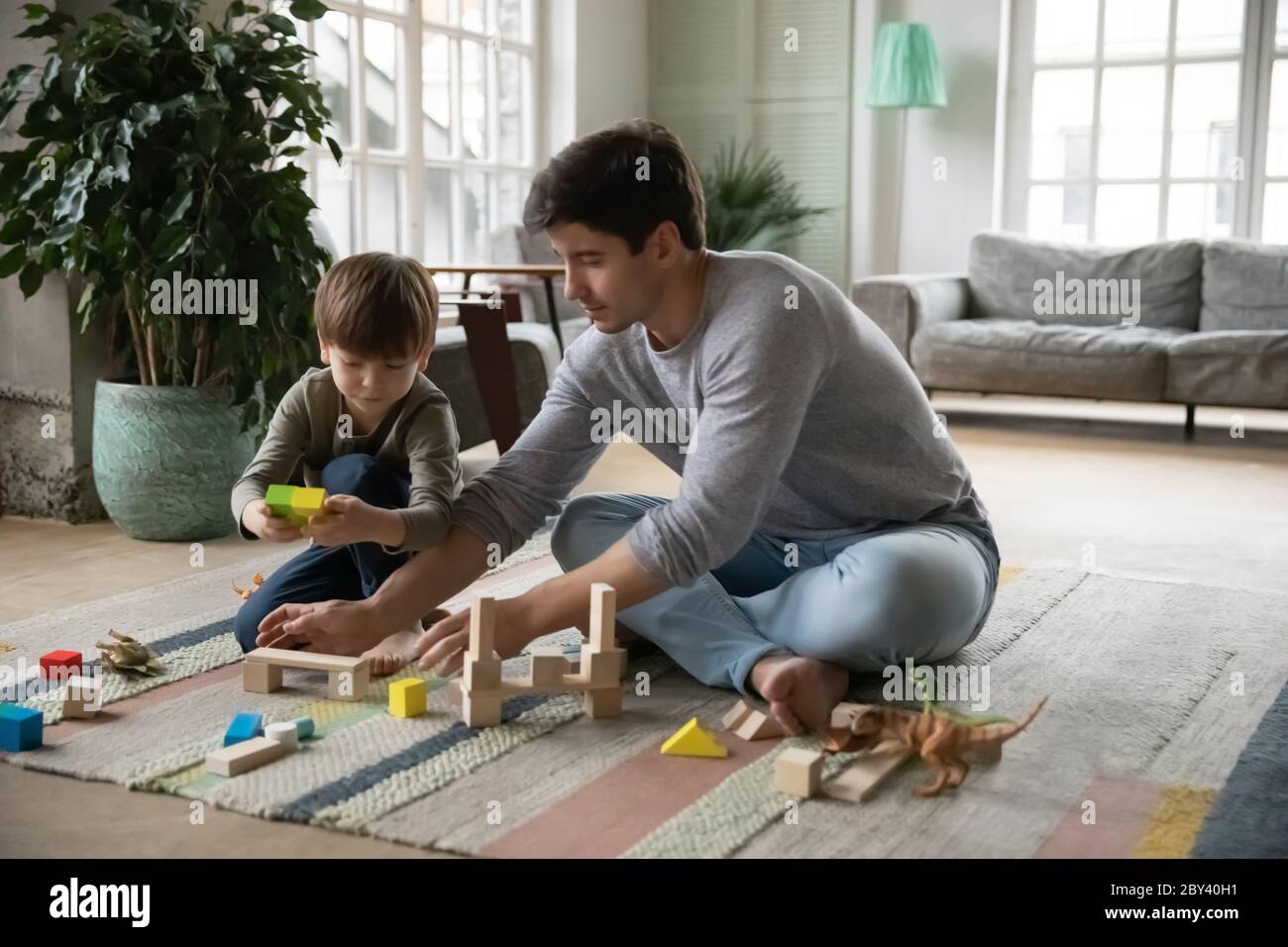 Loving young dad building with bricks play with son Stock Photo - Alamy