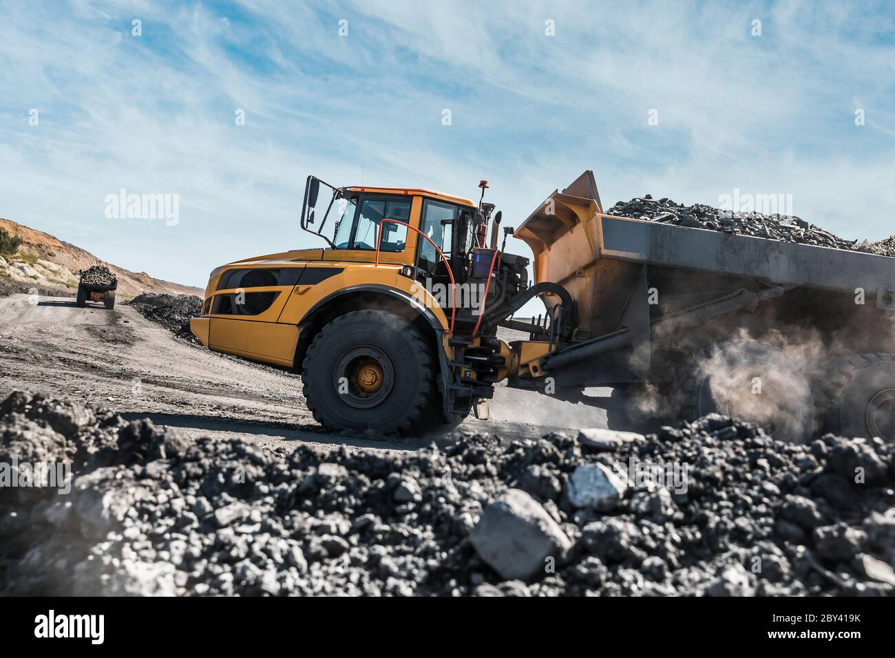 Large quarry dump truck. Loading the rock in dumper. Loading coal into ...