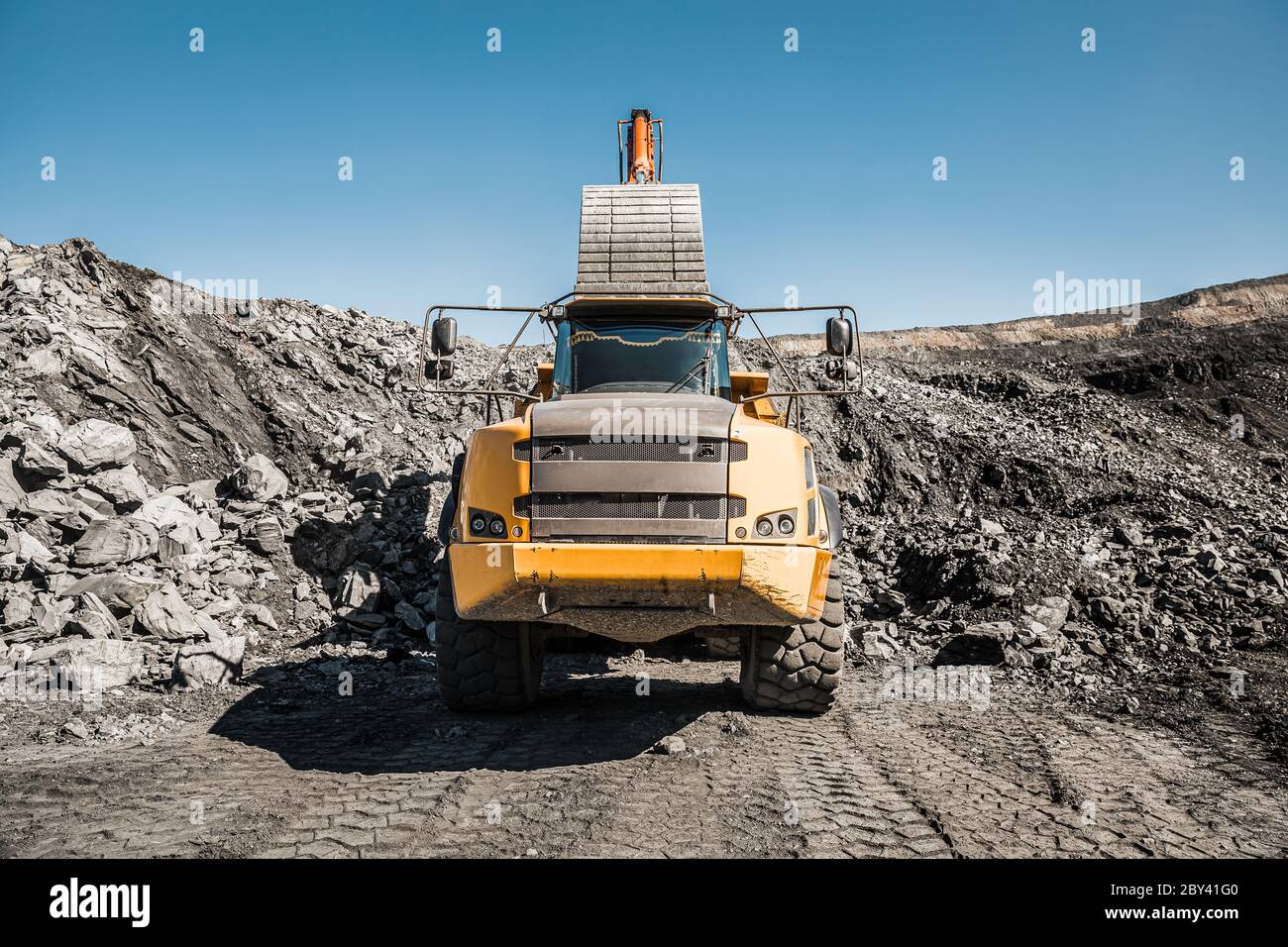 Large quarry dump truck. Loading the rock in dumper. Loading coal into ...