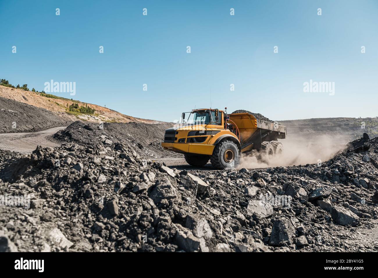 Large quarry dump truck. Loading the rock in dumper. Loading coal into ...