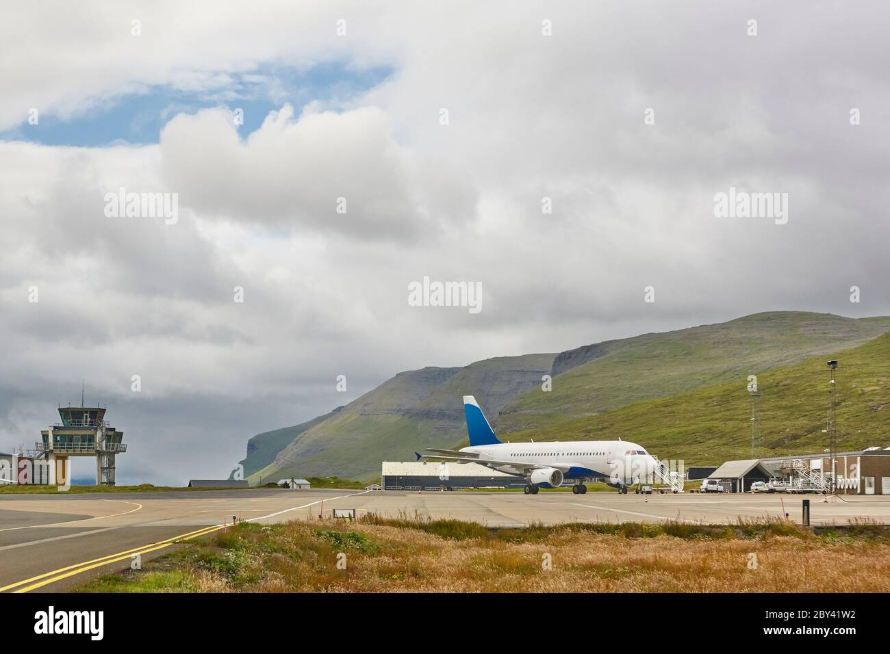 Faroe islands airport runway and control tower with airplane. Travel ...