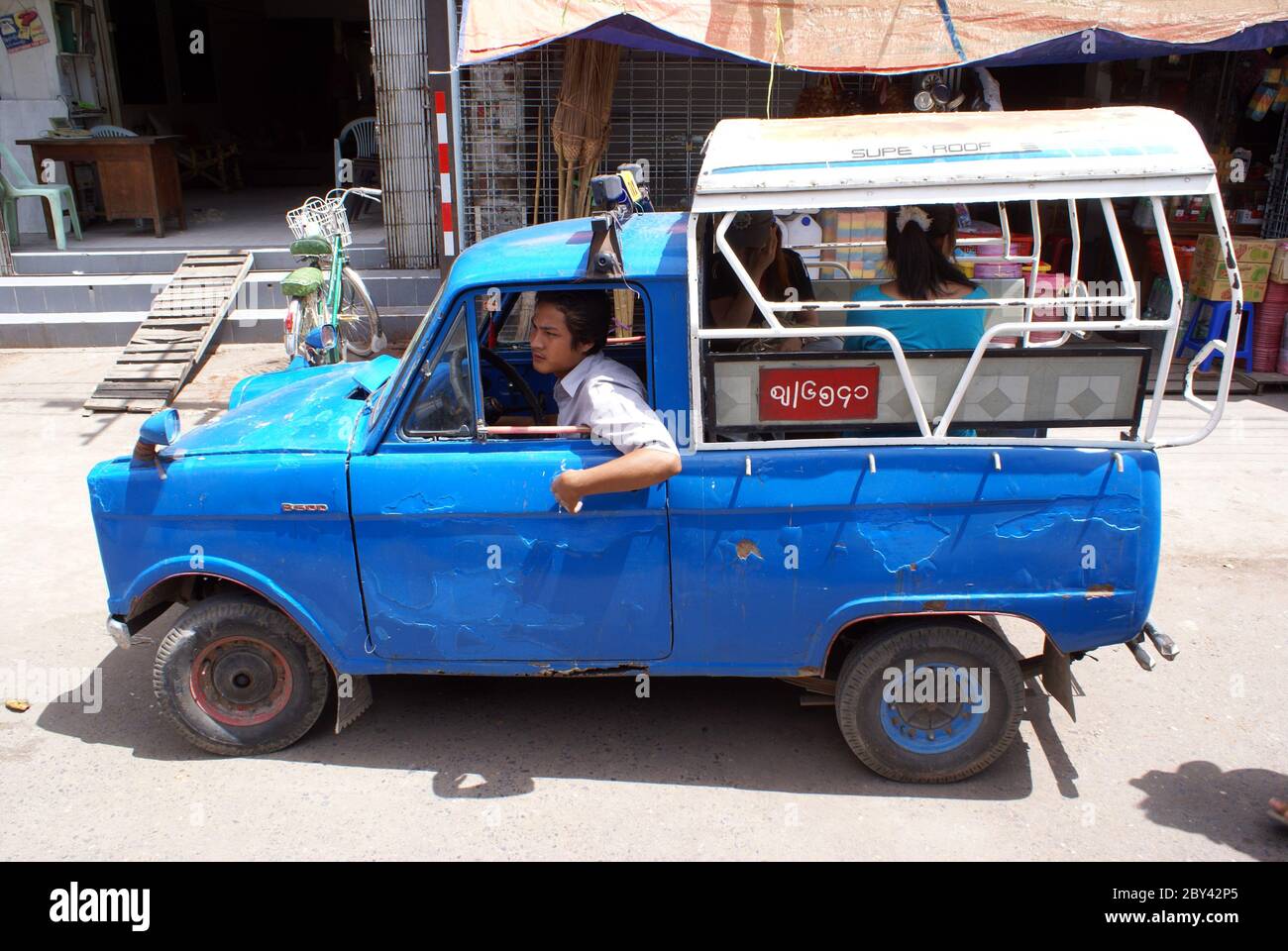 Blue taxi in Mandalay Stock Photo - Alamy