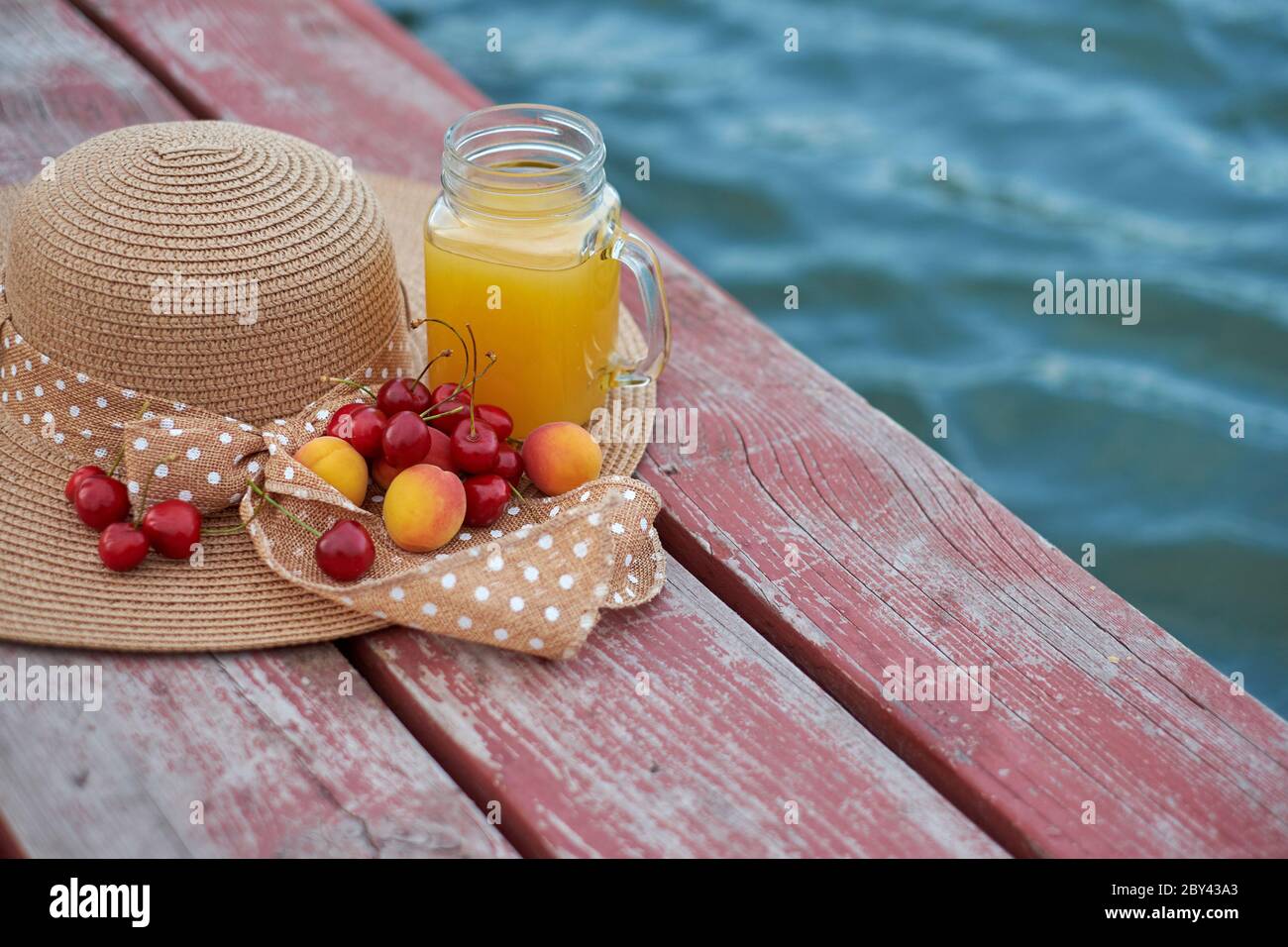 Glass of tropical exotic multifruit juice and fruits at the pier ...